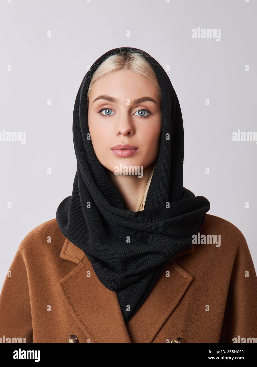 European Muslim woman with a blonde hair in a headscarf shawl dressed ...