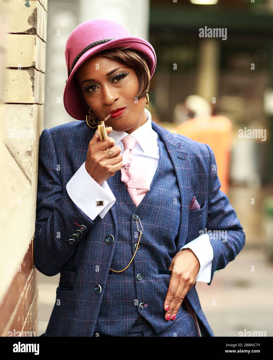 a young woman smoking dressed in a tweed suit Stock Photo - Alamy