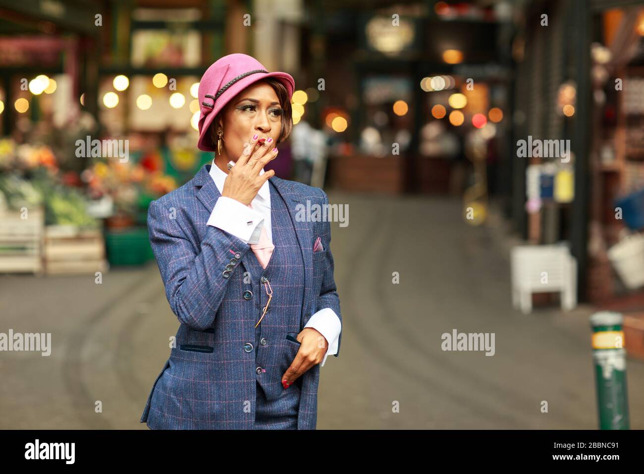 a young woman dressed in a tweed suit smoking Stock Photo - Alamy