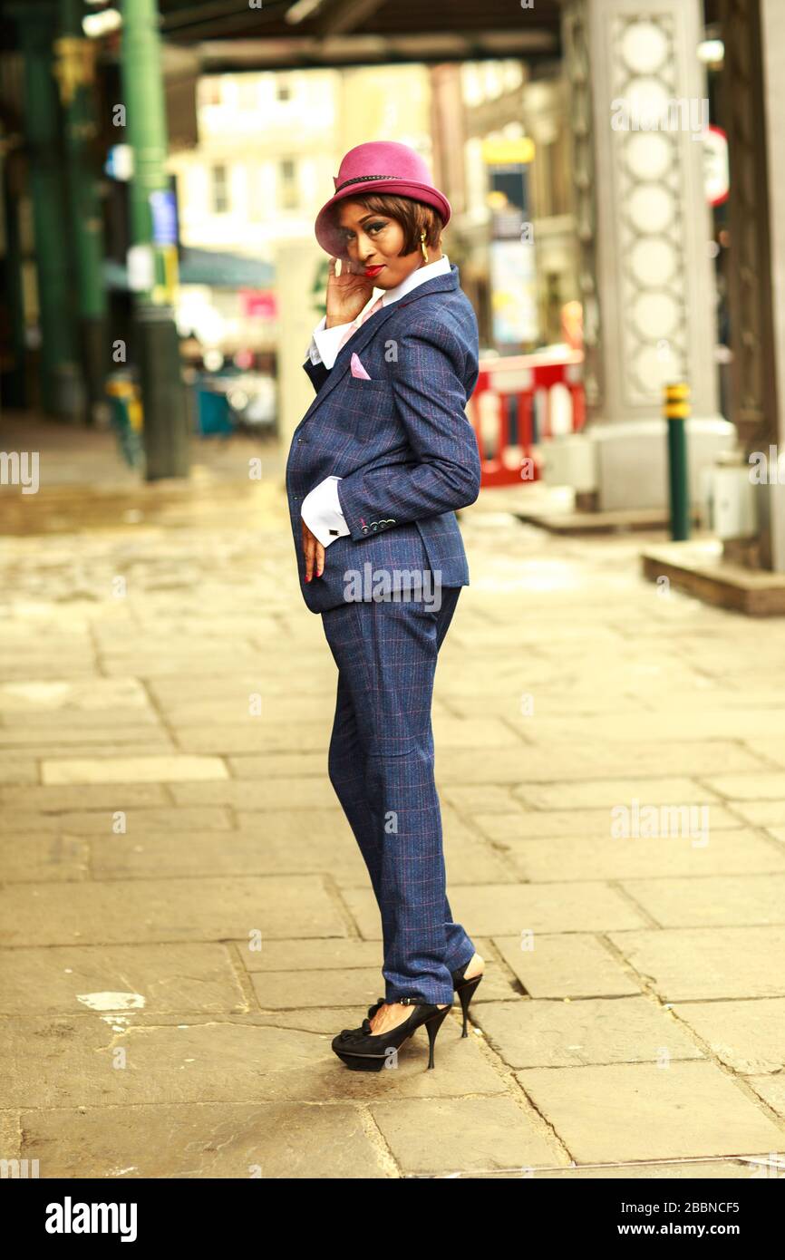 a young woman in a three peace tweed suit smoking Stock Photo - Alamy