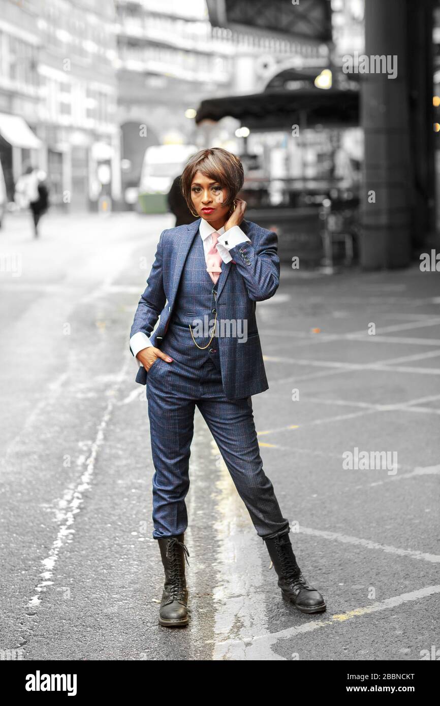 a young woman dressed in a tweed suit smoking Stock Photo - Alamy