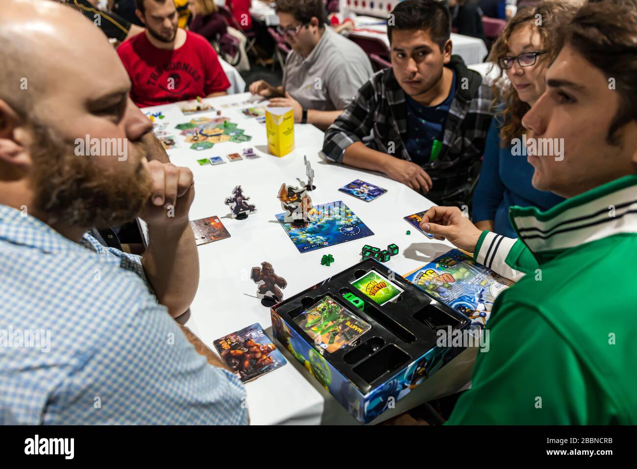 People playing at “King of Tokyo” at the game and toy fair of Quebec ...