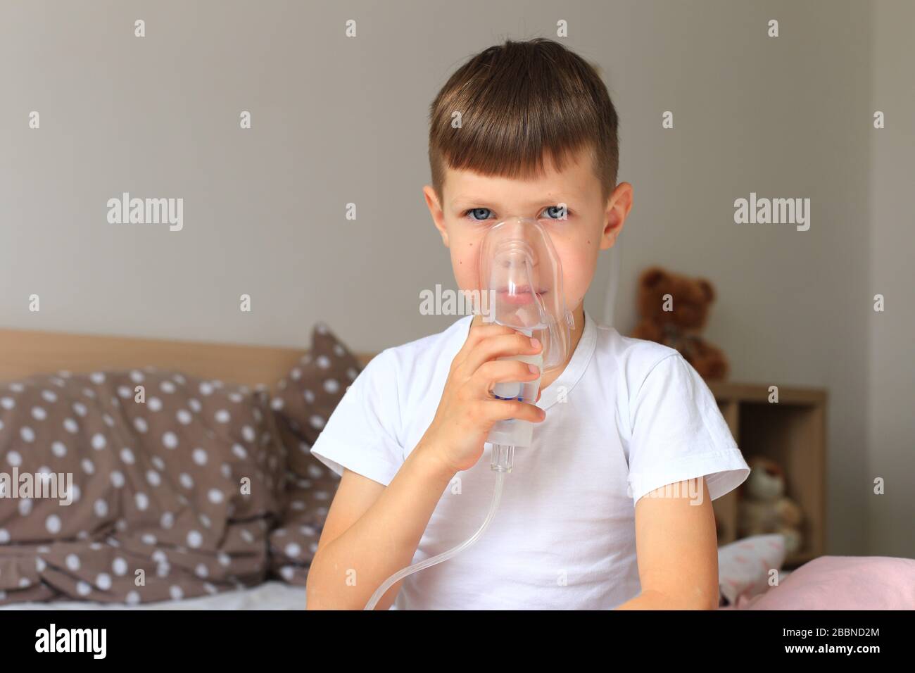 A child with an inhaler. Boy got sick Stock Photo - Alamy