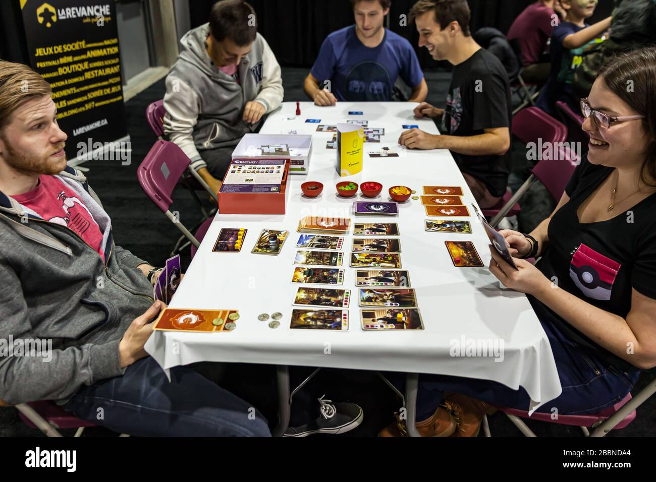 People playing at “Century, Spice Road” at the game and toy fair of ...