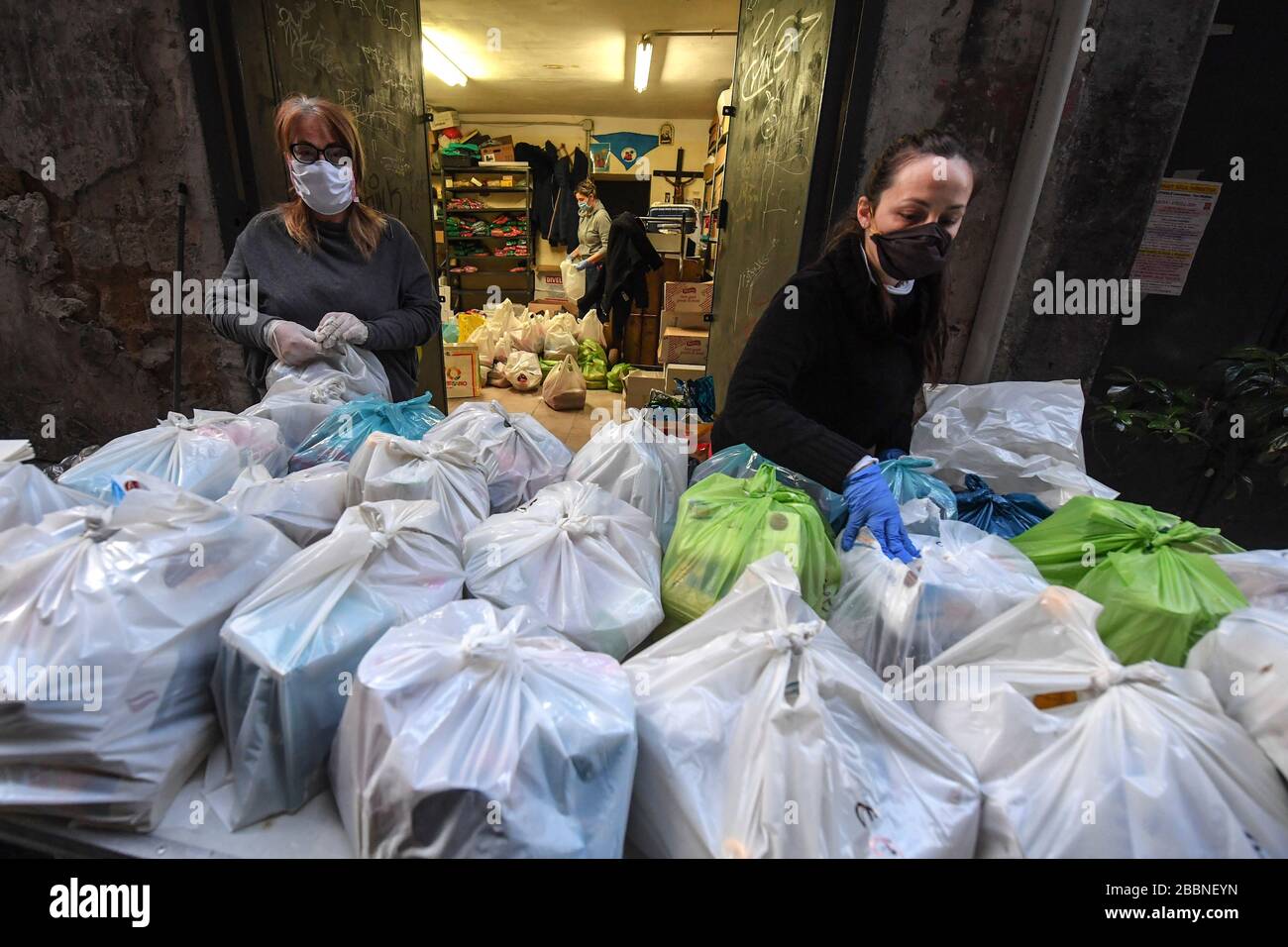 Volunteers prepare packeg of basic necessities, with primary products ...