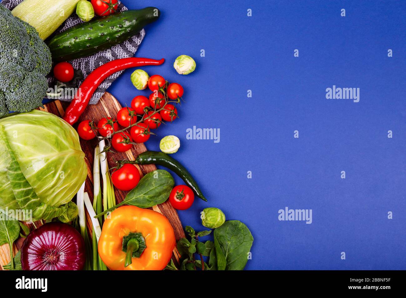 Healthy eating background. Various colorful raw vegetables on blue ...