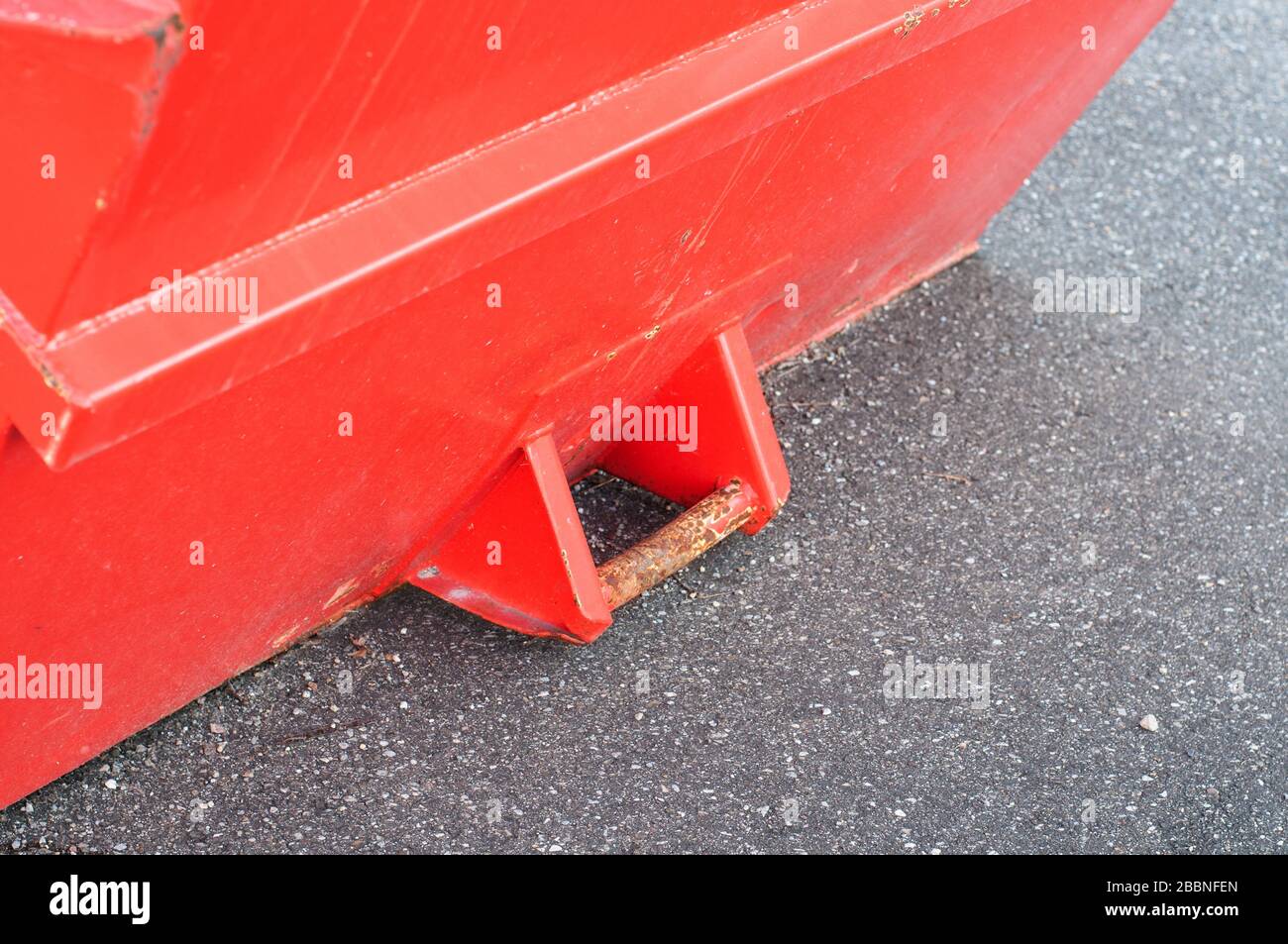 holder at a big red container standing on a tarmac road Stock Photo - Alamy