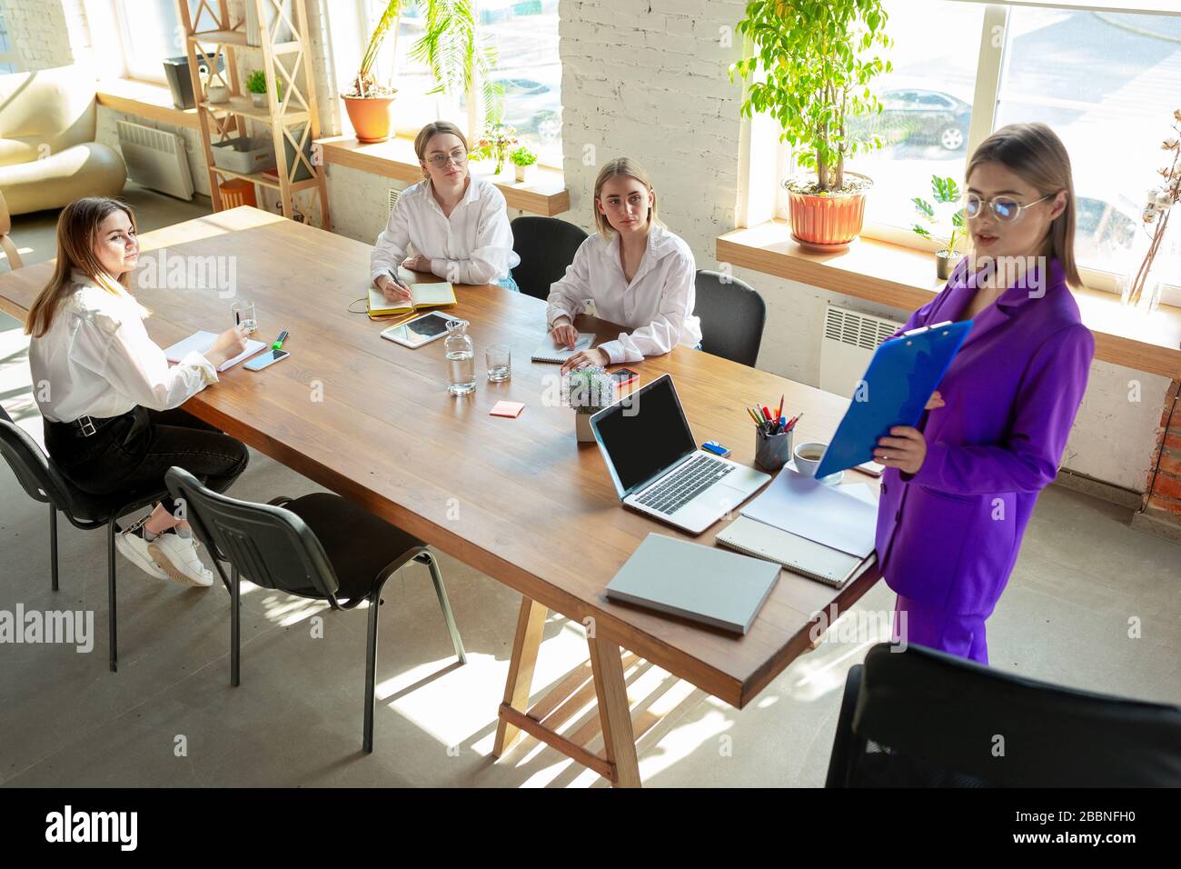 Modern. Young caucasian business woman in modern office with team ...