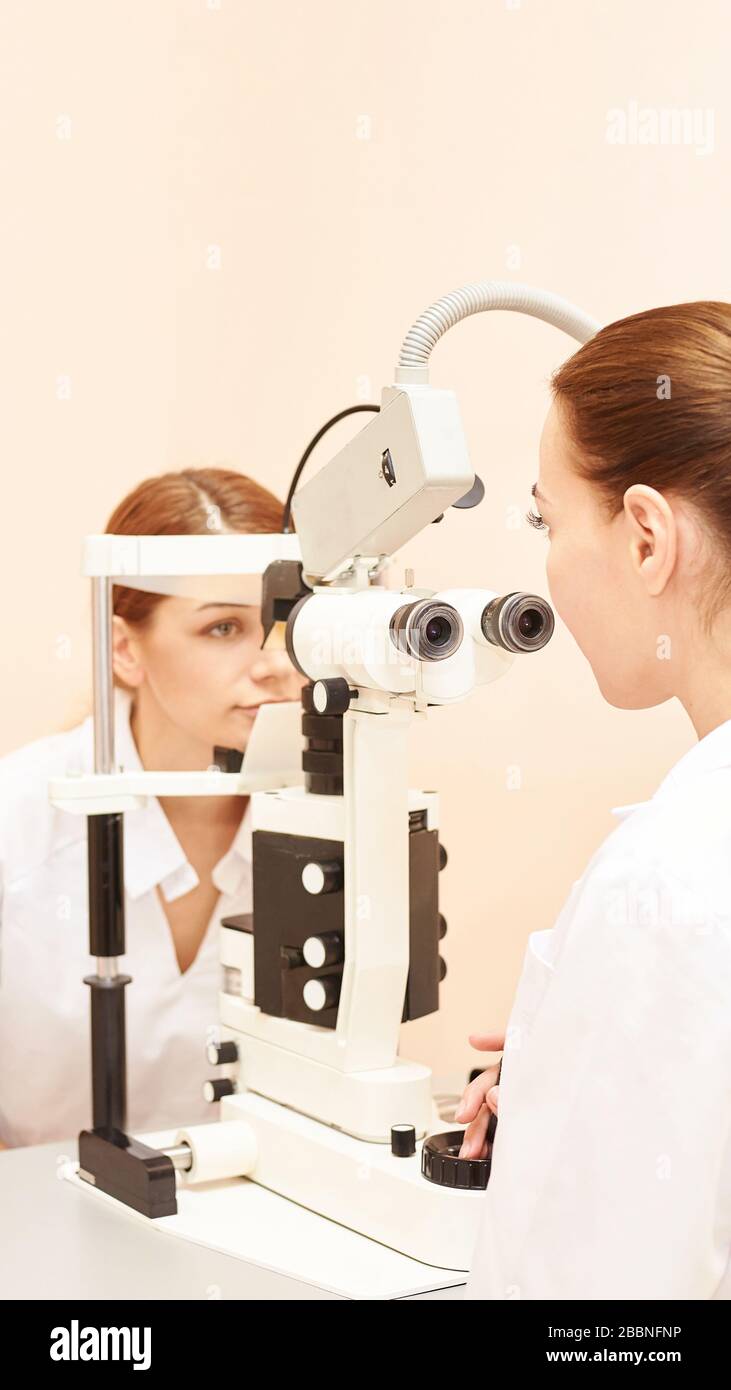ophthalmologist doctor in exam optician laboratory with female patient ...