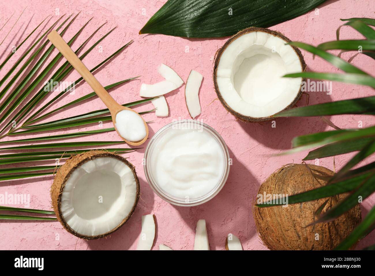 Coconut and cosmetics on pink background, top view Stock Photo - Alamy