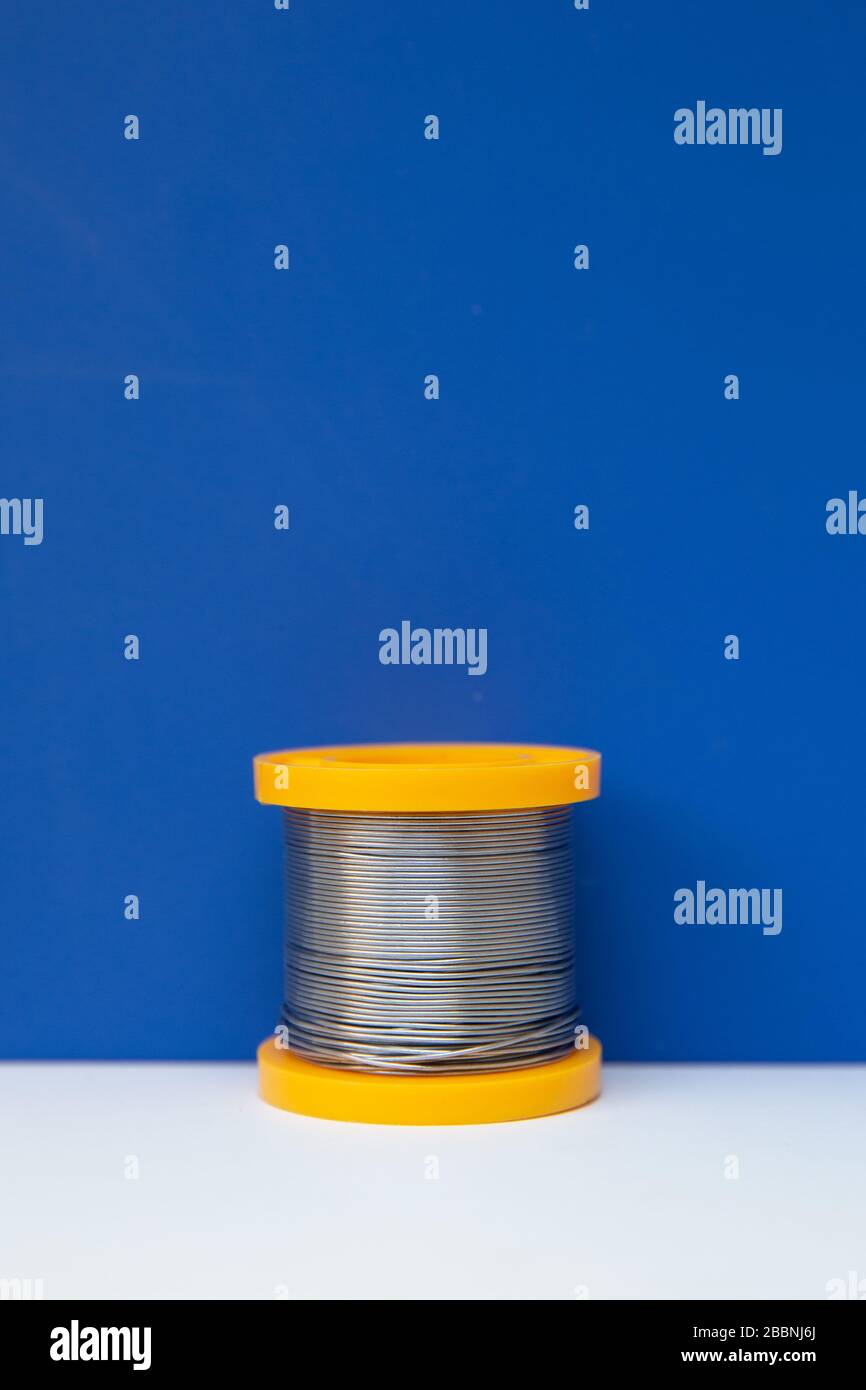 A yellow coil of solder stands in the frame. The coil stands on the ...