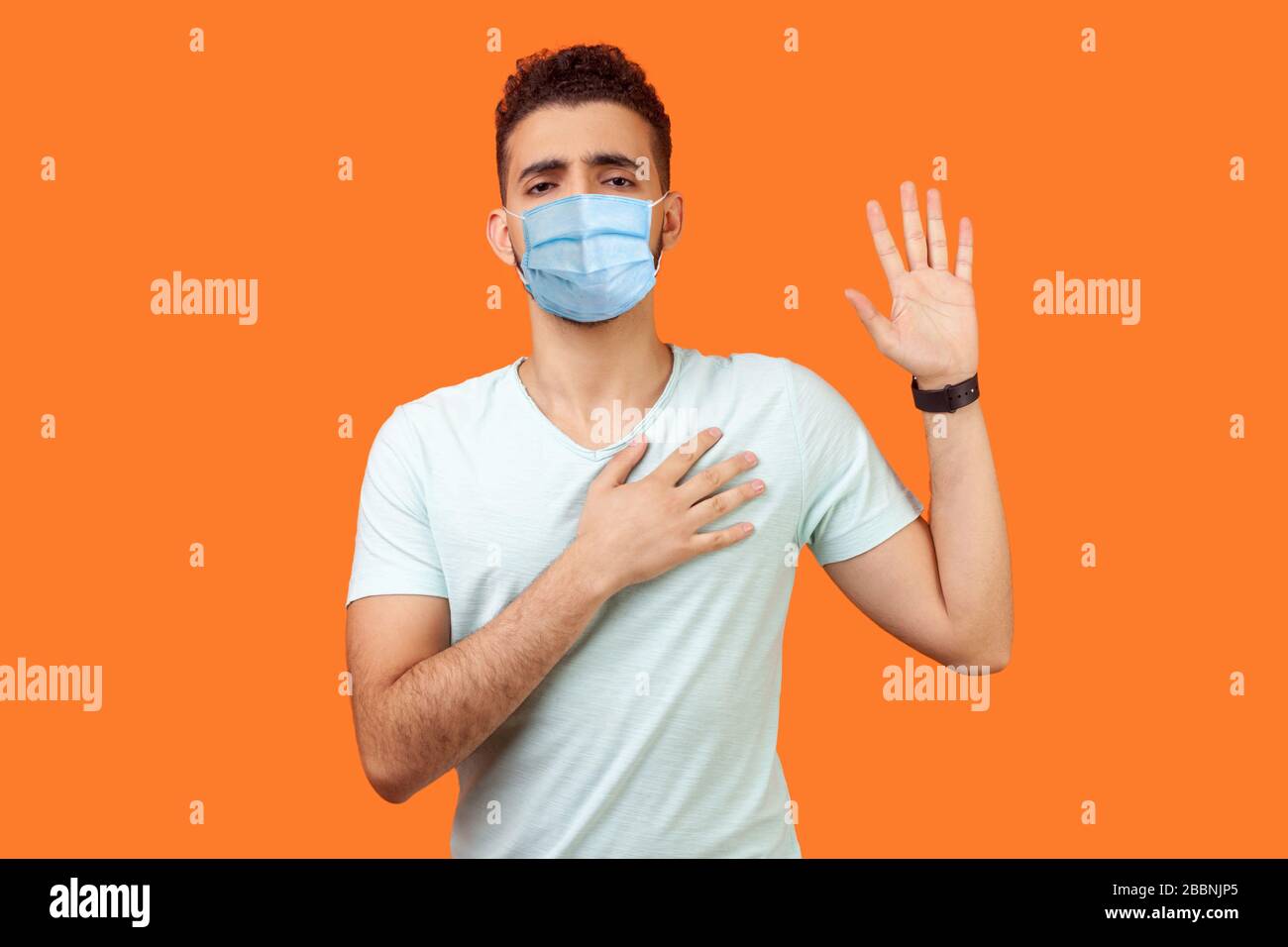 I promise. Portrait of serious brunette man with surgical medical mask ...