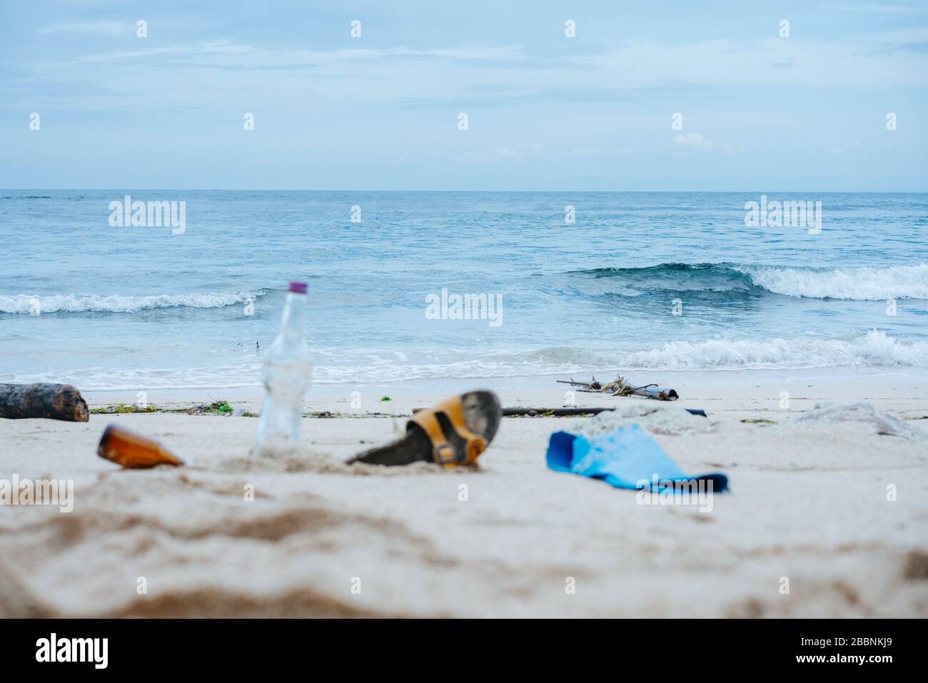 Composition of litter digged in white sand beach of an ocean shore ...