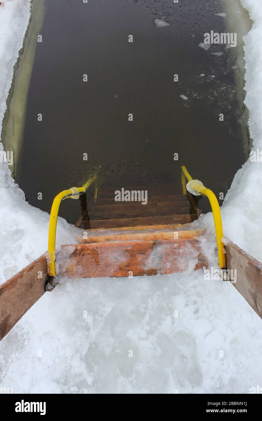 Epiphany ice hole on the Volga in winter, equipped with a ladder for ...