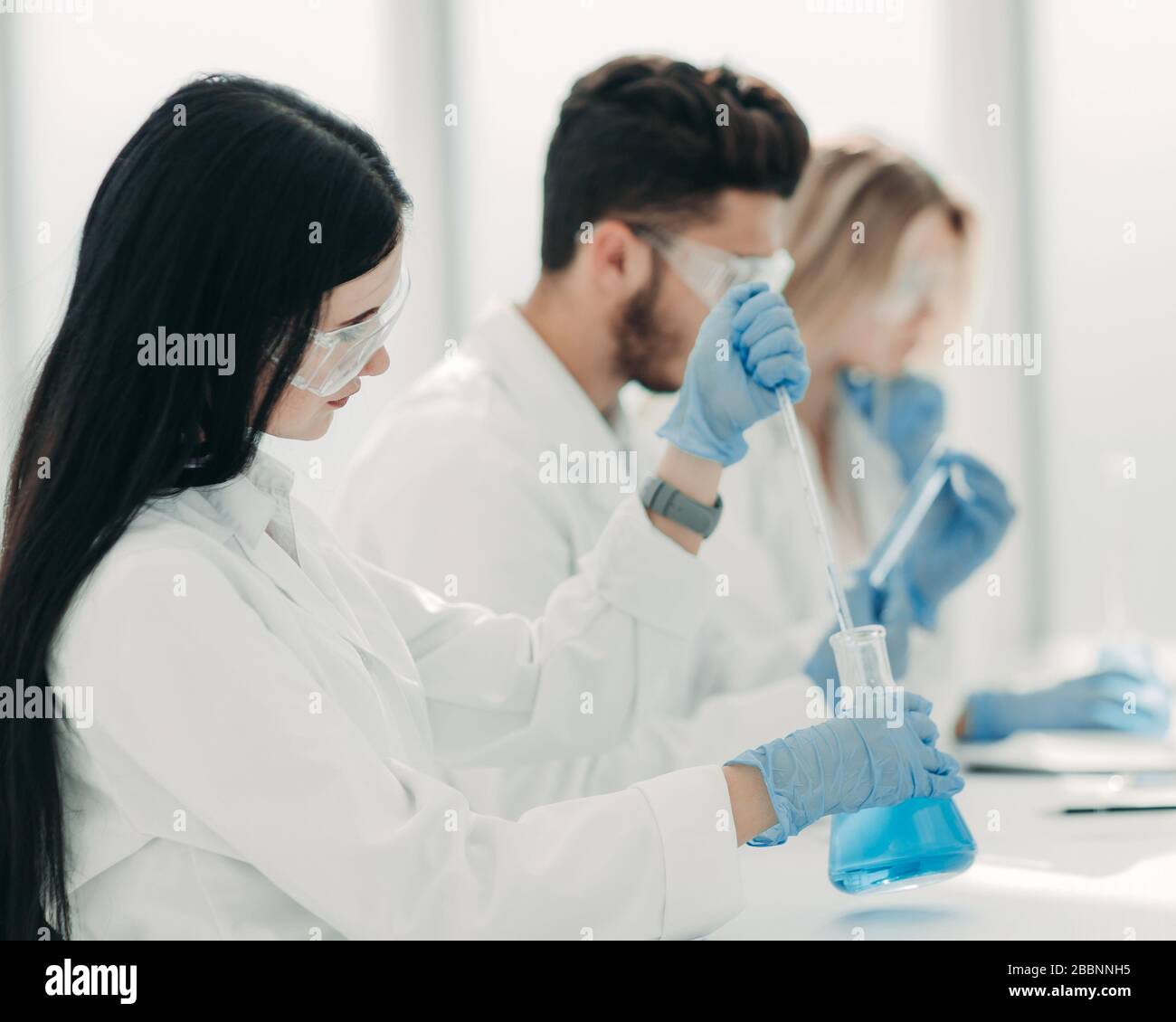 close up.modern woman sitting with colleagues at the laboratory Stock ...