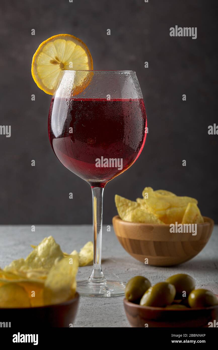 Typical aperitif with red wine and chips Stock Photo - Alamy