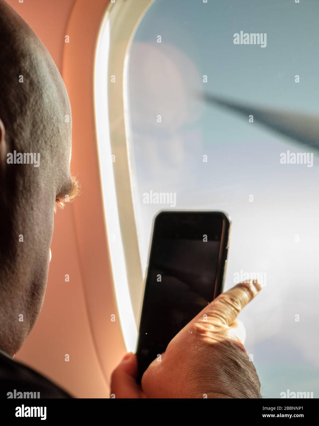 A uses his phone to take a picture out of a Boeing 787 Dreamliner ...