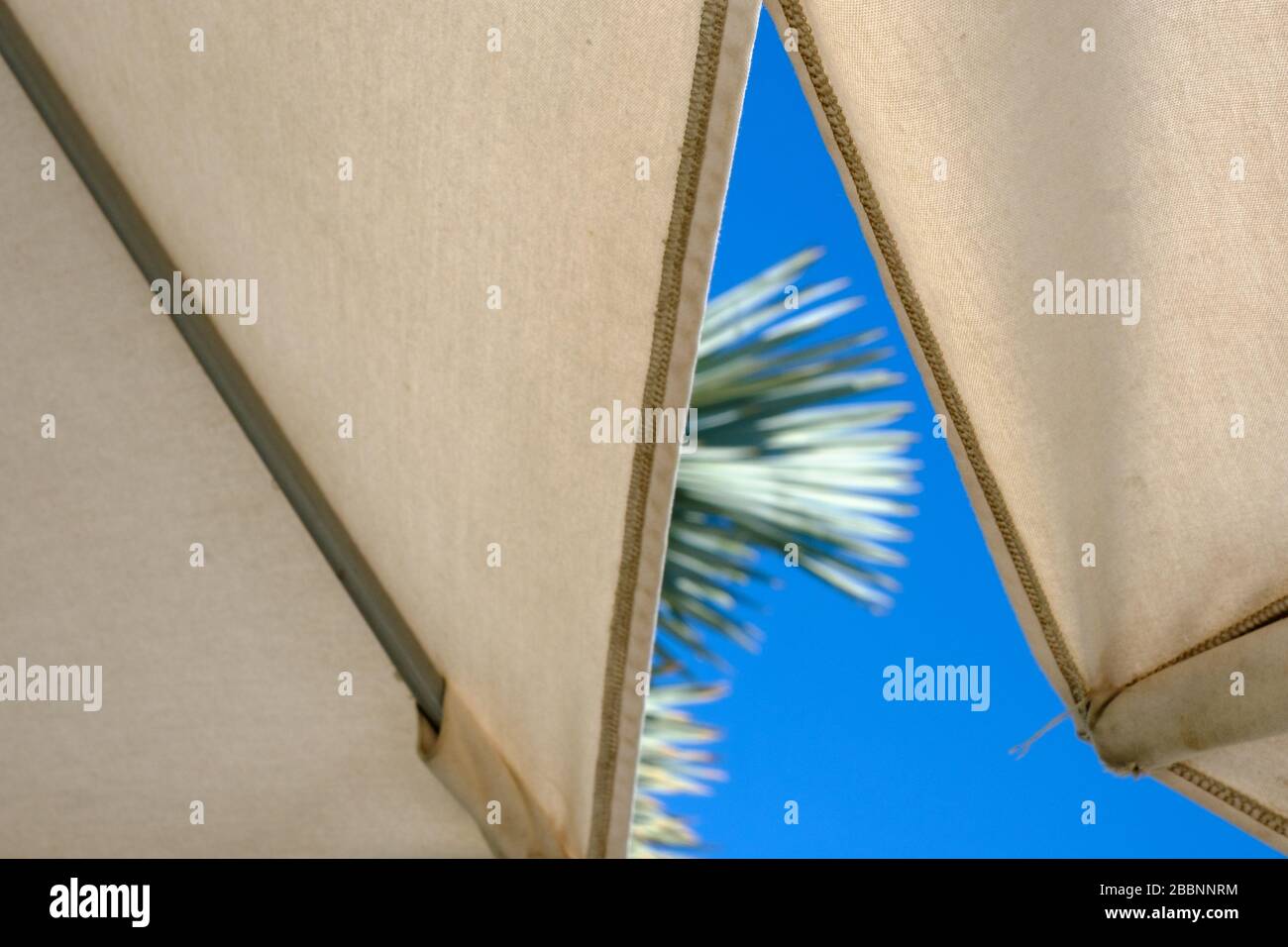 A strong contrast between the man made sun shade and the blue sky at ...