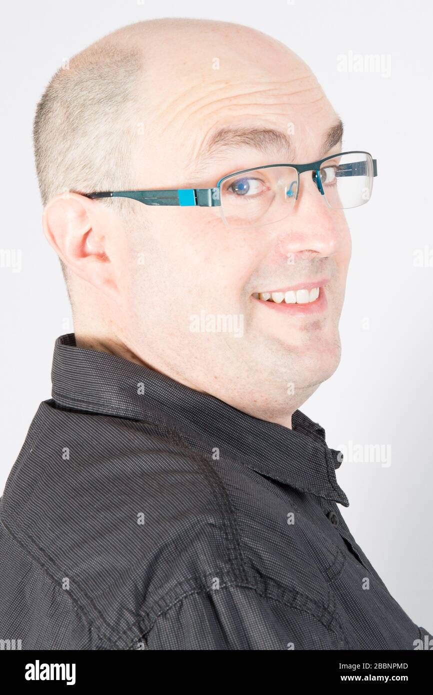 Portrait happy handsome young man turning around smiling looking Stock ...