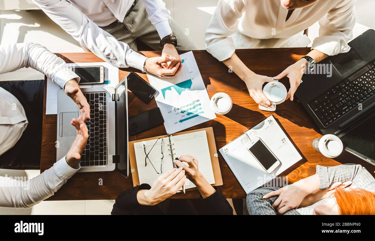 A team of young businessmen working and communicating together in an ...