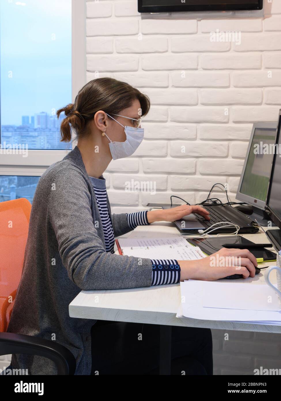 A sick quarantined girl works at a computer Stock Photo - Alamy