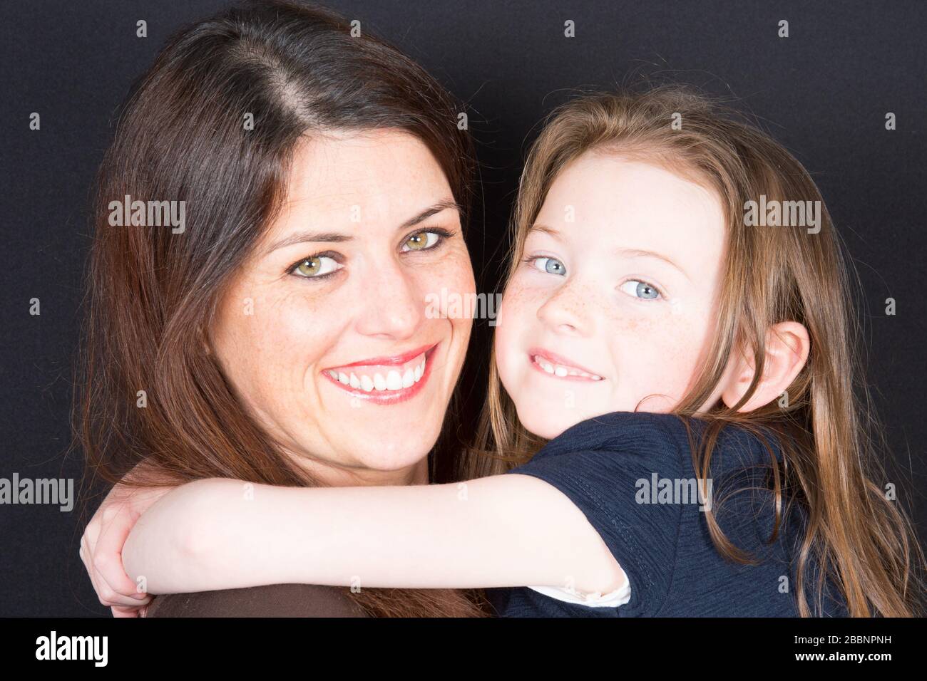 Happy smiling mother and daughter embracing Stock Photo - Alamy