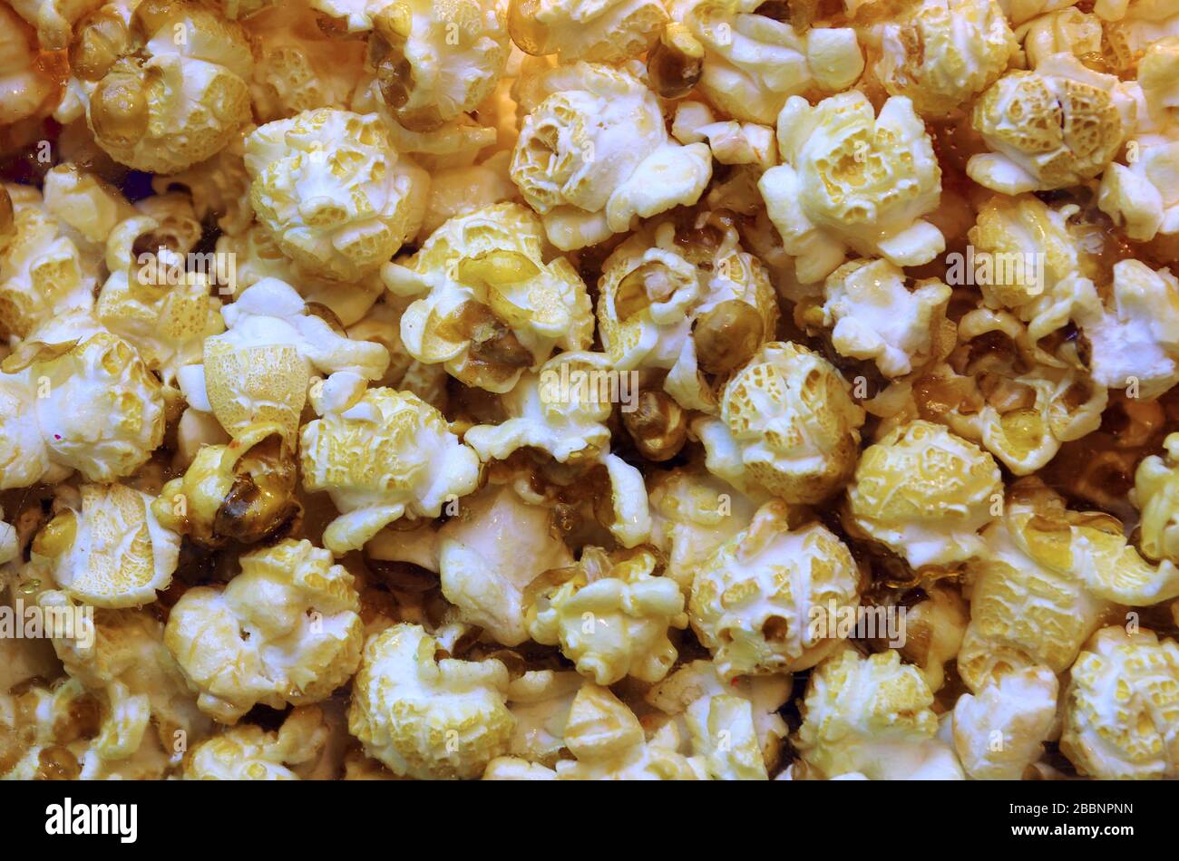 Sweet golden popcorn background Stock Photo - Alamy
