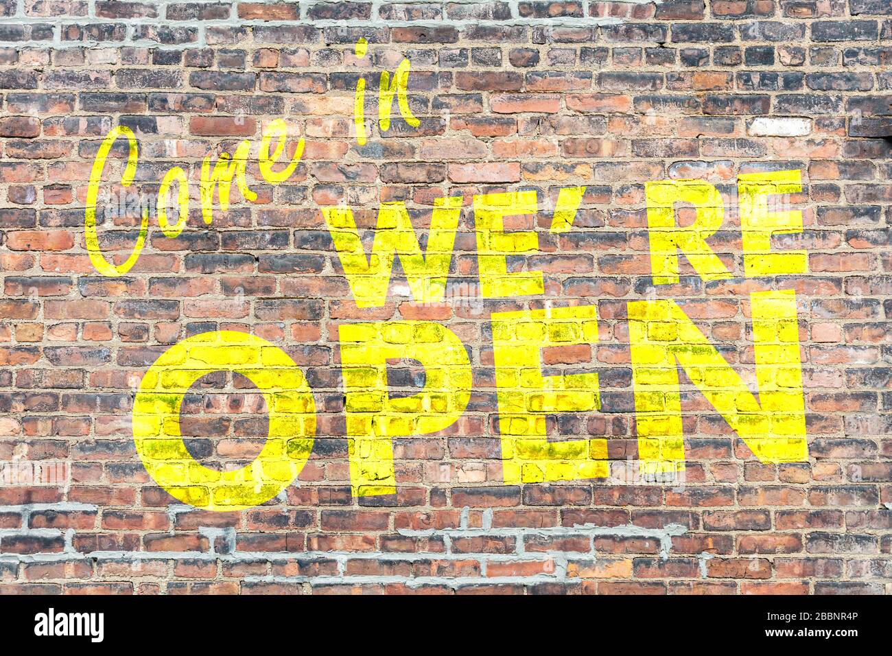 Open come in store sign. Yellow color text Come in we re open on brick ...