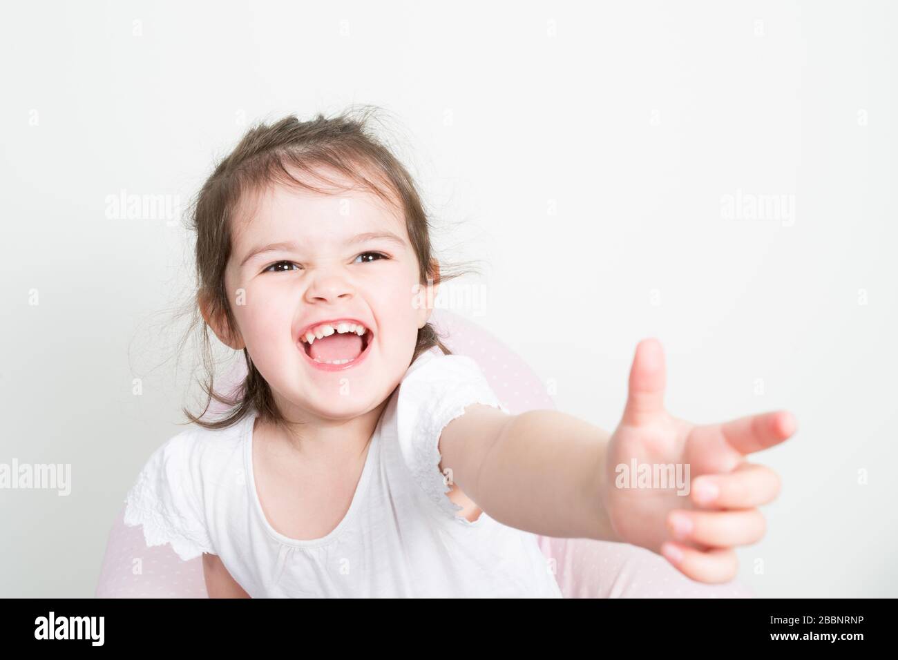 beautiful excited child girl hold hand up happy isolated on white ...