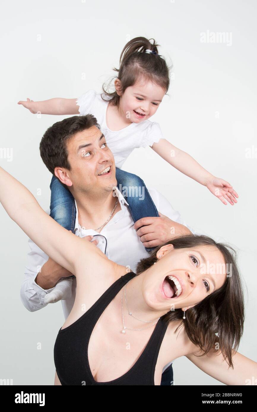 Happy family of three have fun play piggyback daughter mother and ...