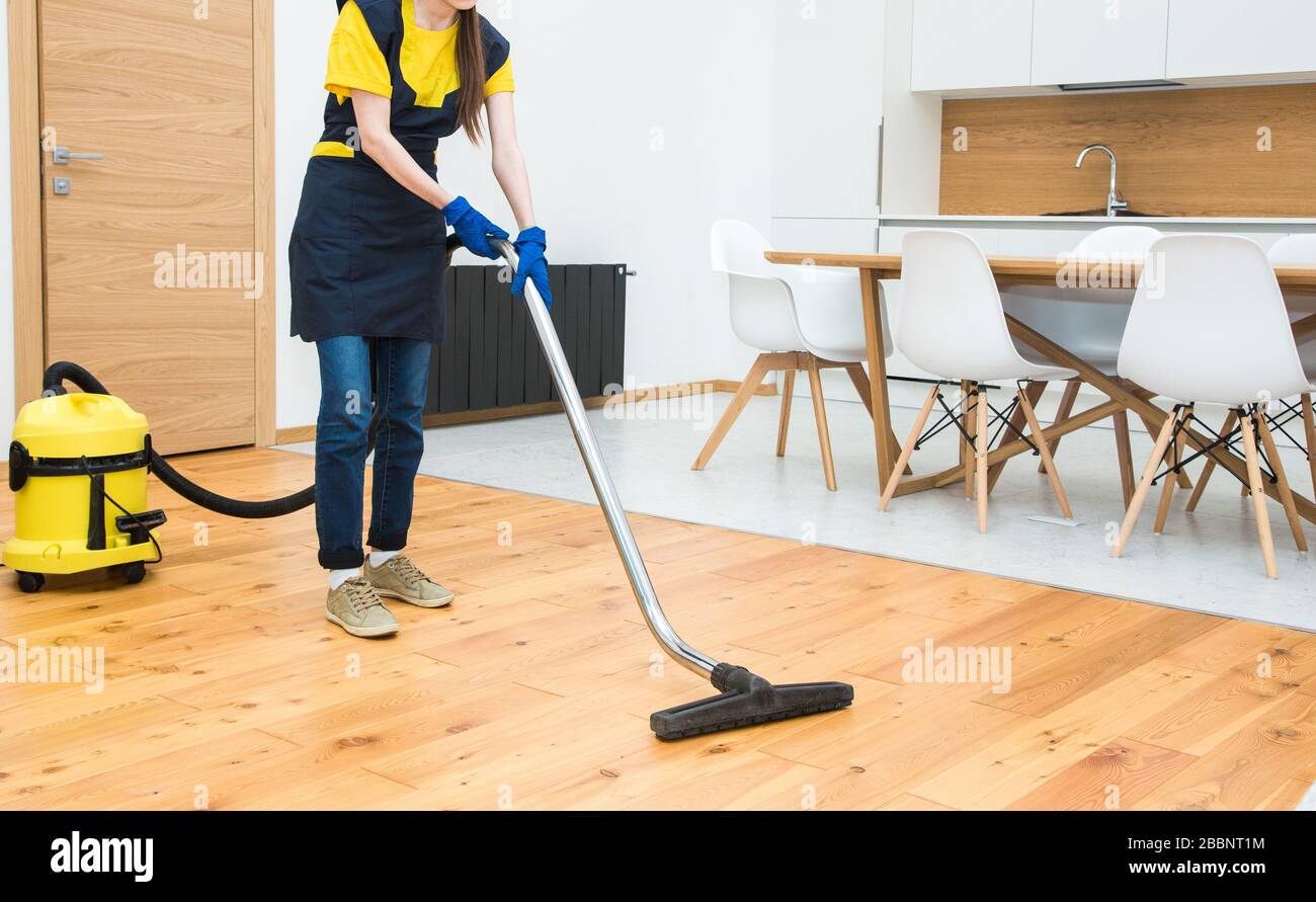 professional cleaning service. woman in uniform and gloves does the ...
