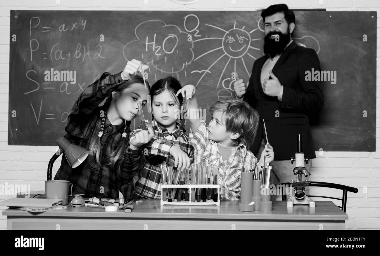 back to school. kids in lab coat learning chemistry in school ...