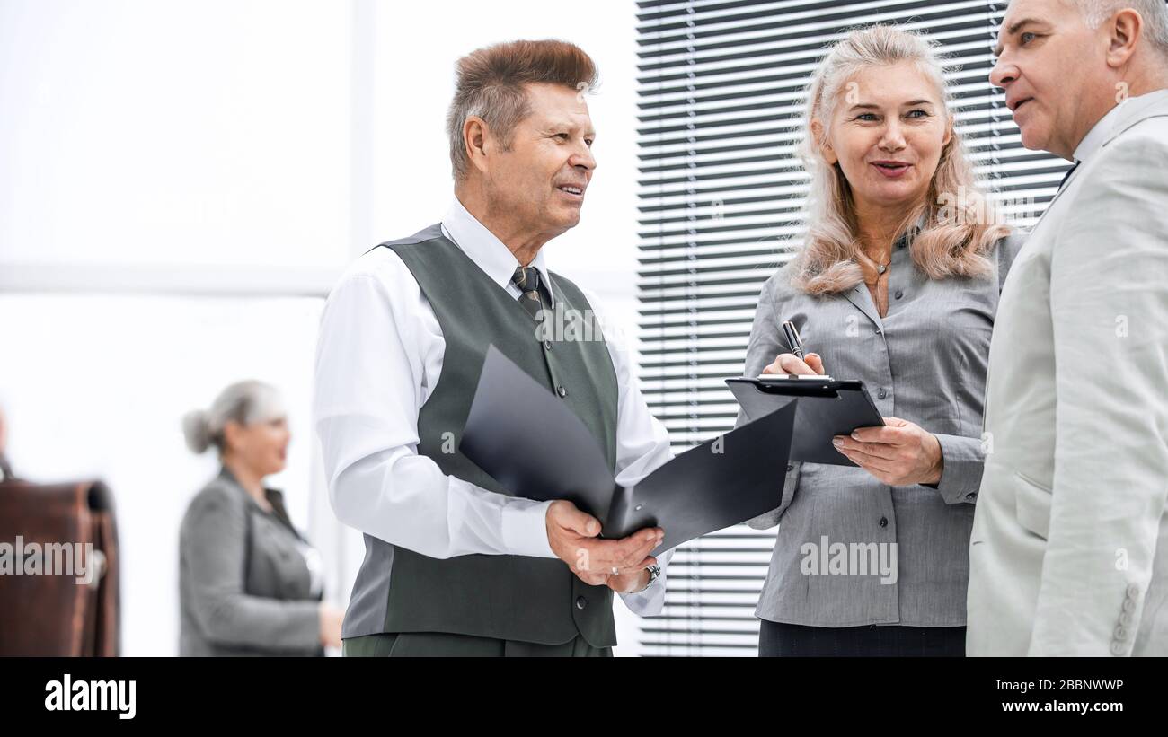 close up. group of employees discussing documents standing in the ...