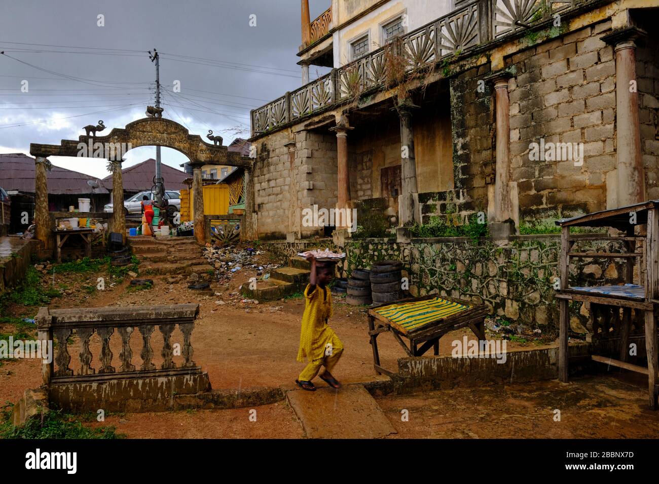 Boy with a tray on his head escaping the rain Stock Photo - Alamy