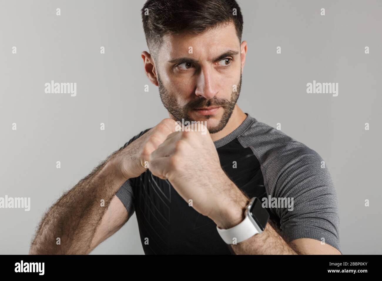 Image of a handsome strong sportsman fighter isolated over grey wall ...