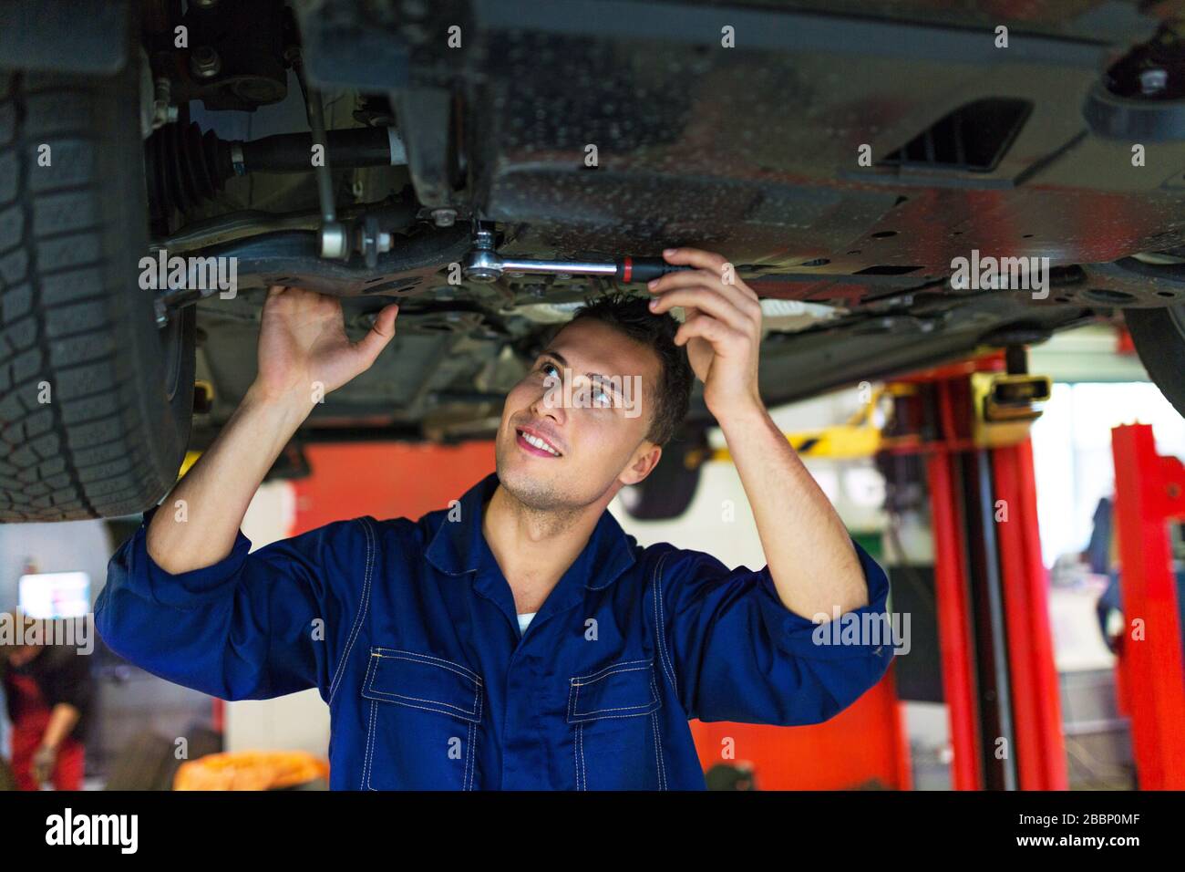 Mechanic working in auto repair shop Stock Photo - Alamy