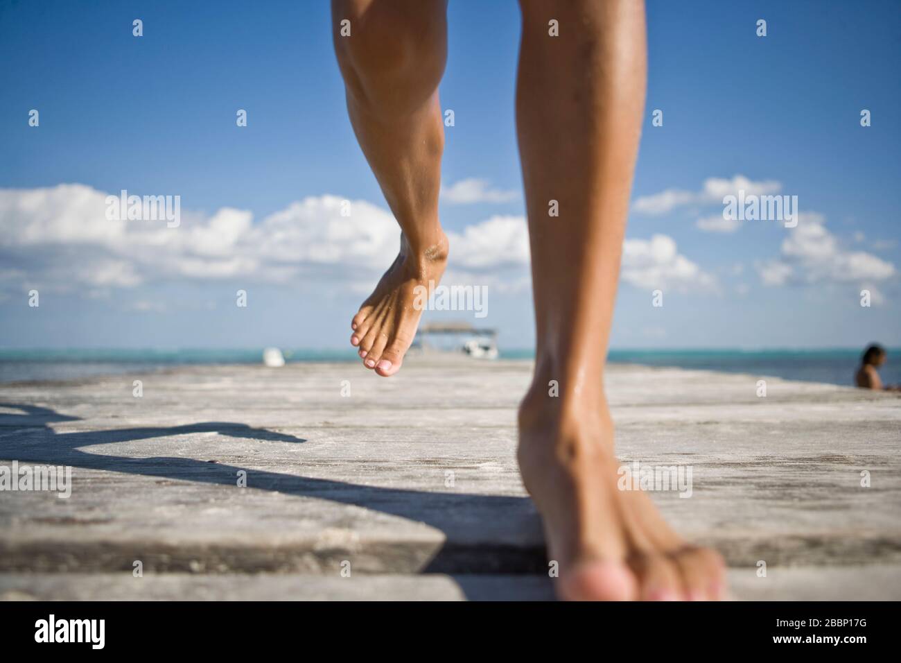 Legs running on a jetty Stock Photo - Alamy