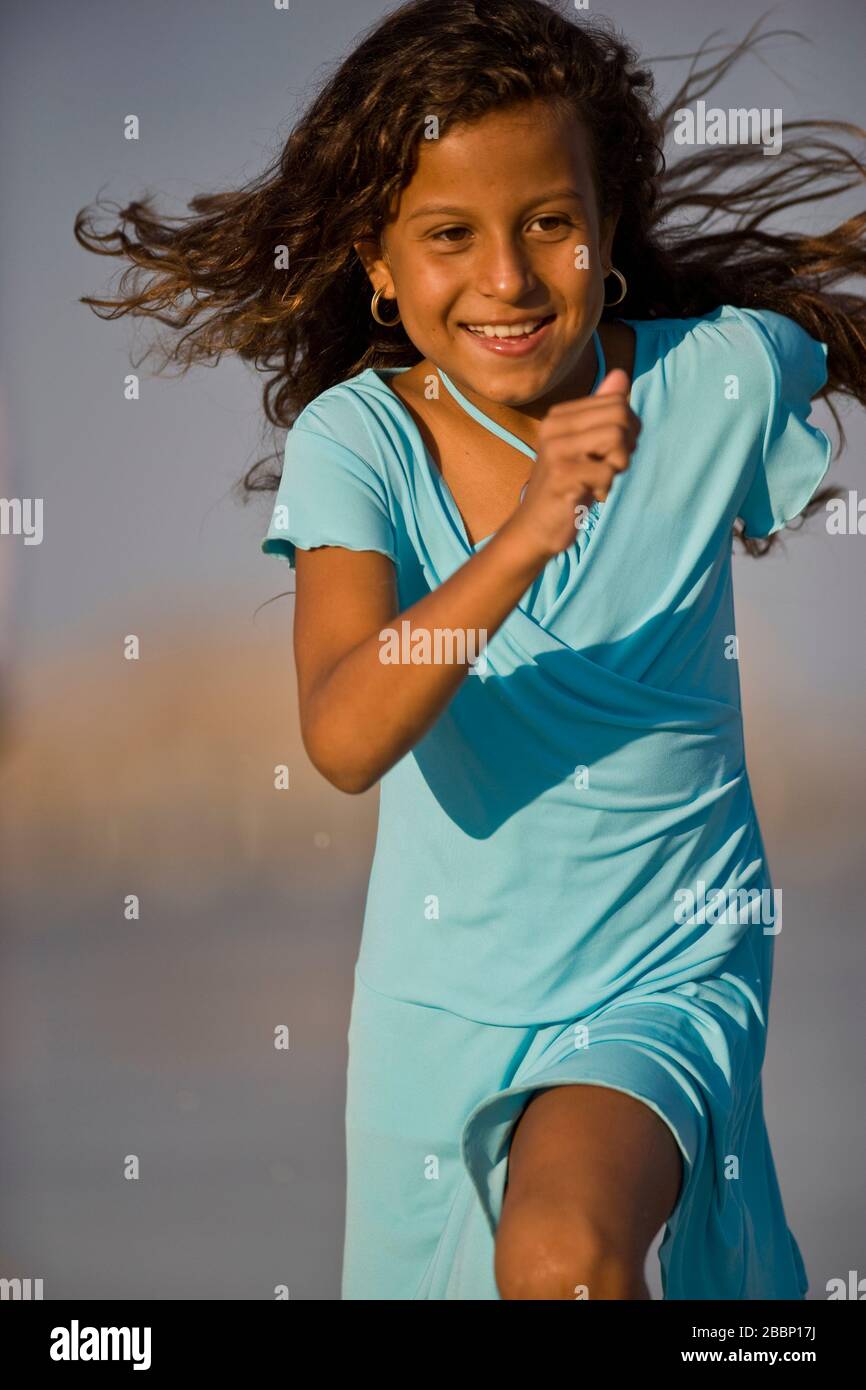 Child playing in the water in the sand wearing blue hi-res stock ...
