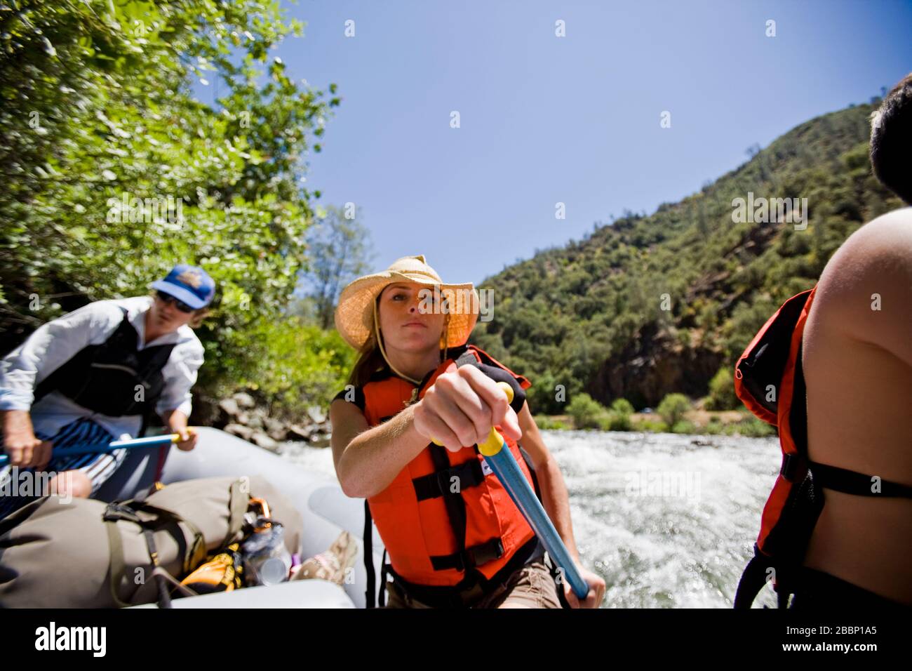 Young adult girl and friend rafting along a river Stock Photo - Alamy