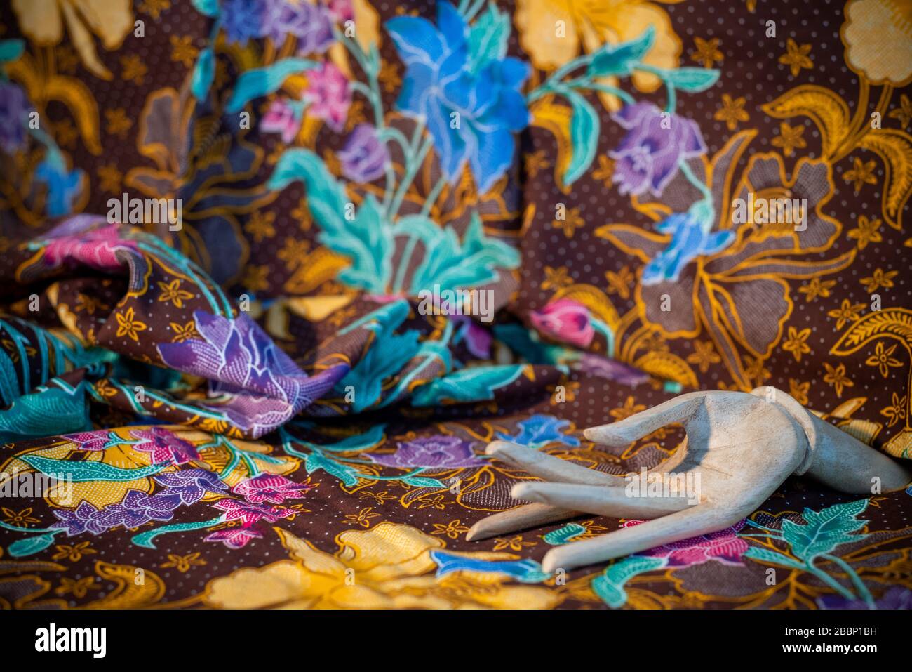 Buddha hand and patterned batik Stock Photo - Alamy
