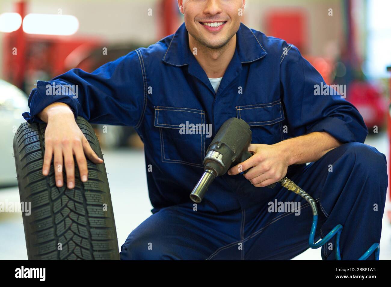 Mechanic working in auto repair shop Stock Photo - Alamy