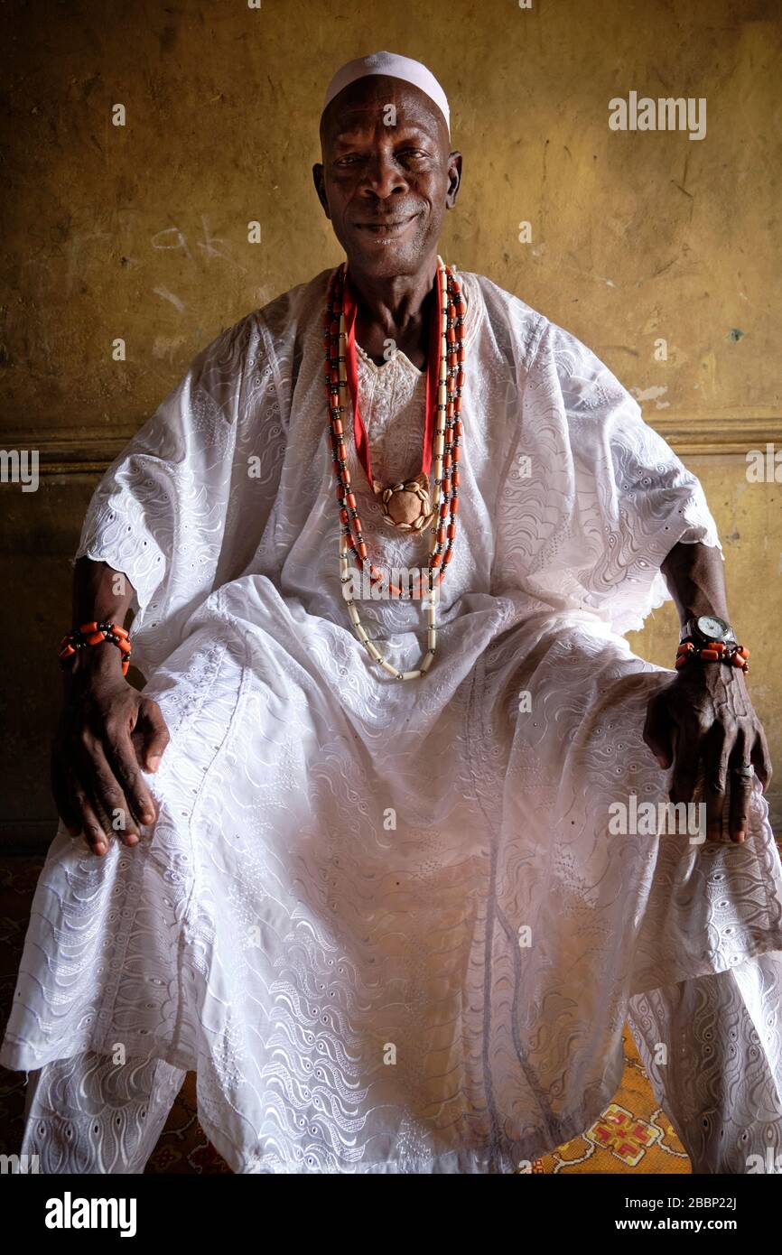Portrait of a Yoruba priest with traditional amulets, robes and ...