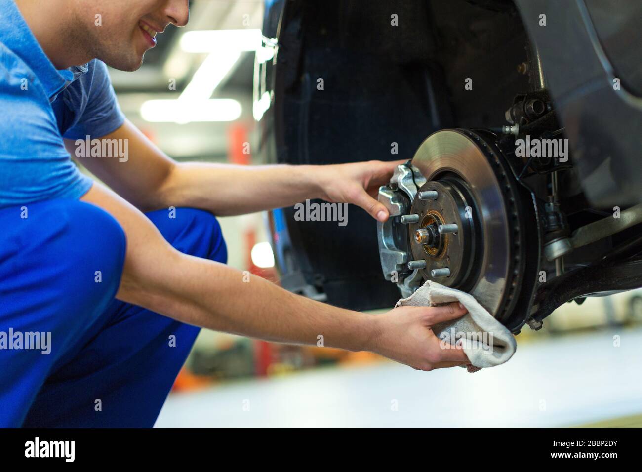 Mechanic working in auto repair shop Stock Photo - Alamy