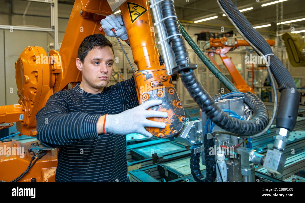 dismantling the robotic arms in the factory when relocating production ...
