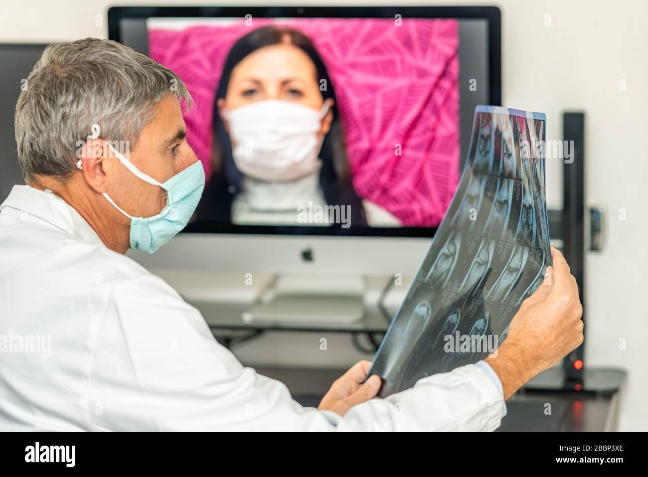Back view of doctor making video call with his patient at home. Close ...