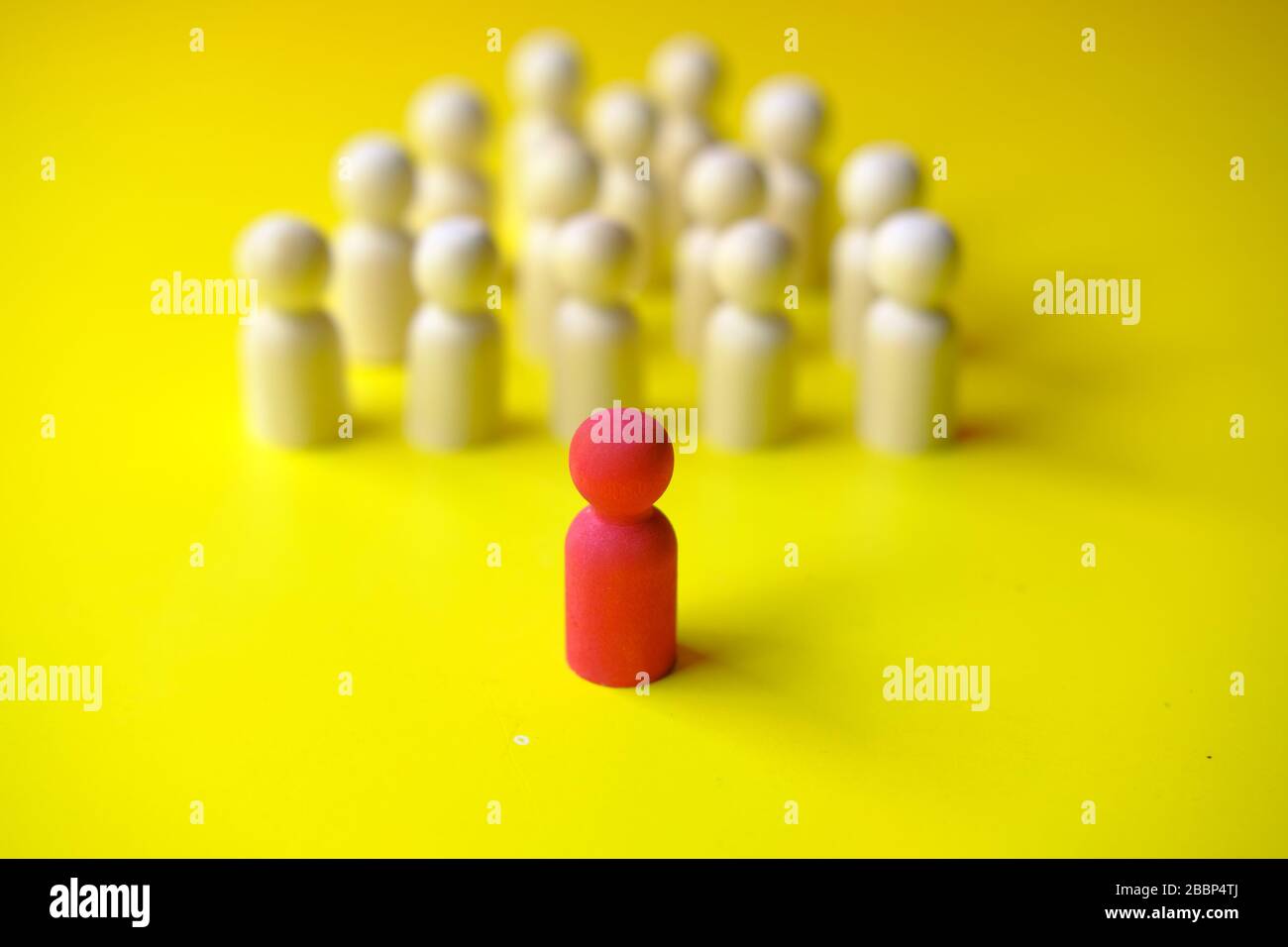 A stick wood block standing in front of a group of round wood block ...