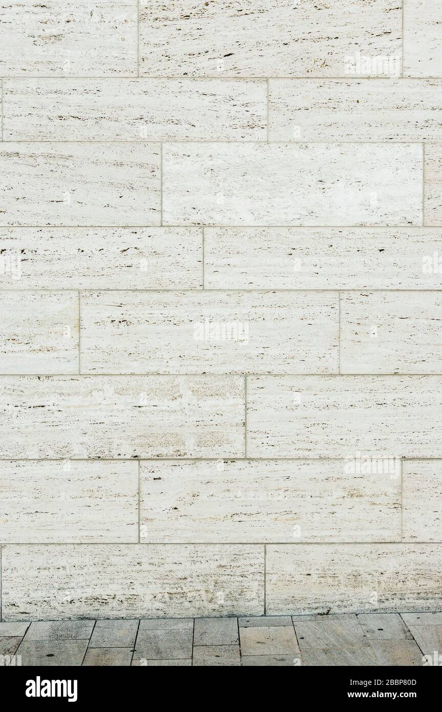 Travertine facade as background with a small piece of travertine stone ...