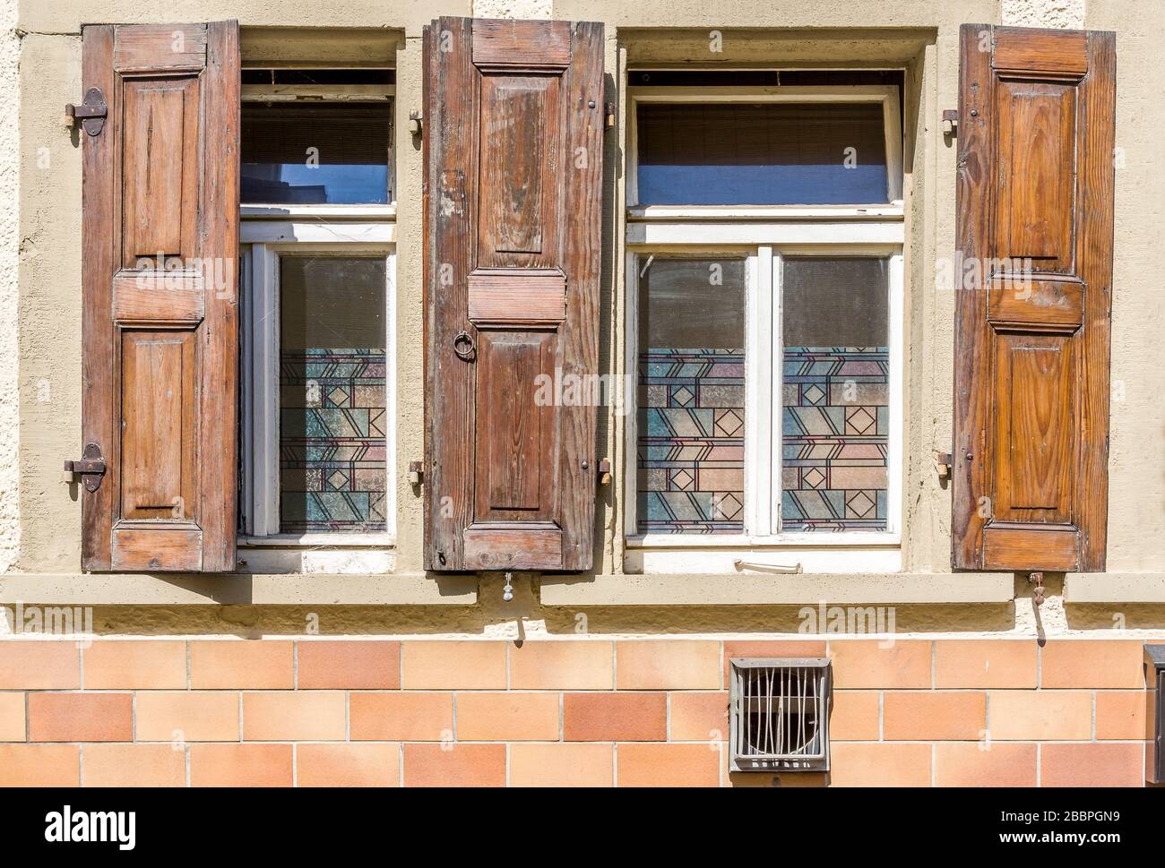 Facade with windows with stained glass and wooden shutters Stock Photo ...