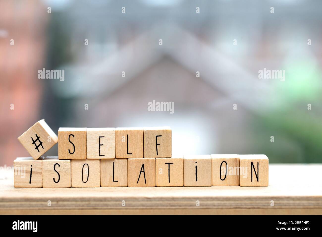 Wooden cubes with the word Self isolation and a question mark for Covid ...