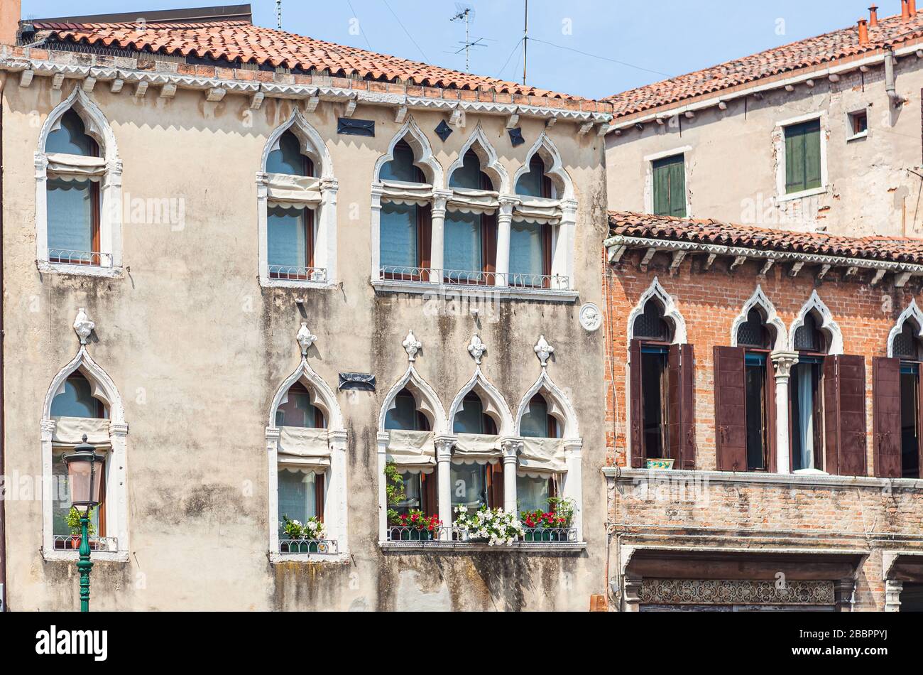 Facade of venetian houses with typical old venetian windows on it ...